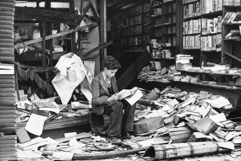 Boy reading in bombed London library, 1940 - WW2 HistoryBook